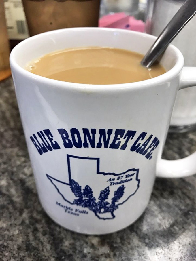 A mug of coffee that promises to keep you company through pie deliberations. The Blue Bonnet logo reminds you exactly where this moment of caffeinated bliss is happening.