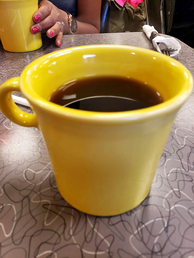 That sunshine-yellow mug isn't just holding coffee&mdash;it's holding liquid motivation. The diner coffee here actually tastes like... coffee!