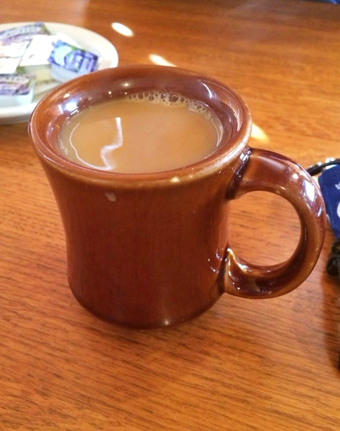 That sturdy brown mug doesn't just hold coffee; it holds the promise of a day that starts right. Simple pleasures in ceramic form.