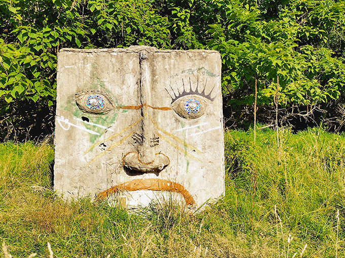 "I've seen things," this concrete visage seems to say, its weathered features and mosaic-like embellishments creating a face that's equal parts guardian and greeter.