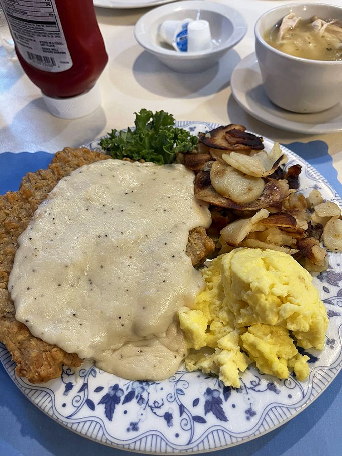 Country fried steak smothered in gravy that could make a vegetarian question their life choices, paired with eggs that sunshine yellow should be trademarked.