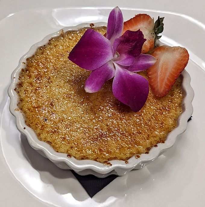 The cr&egrave;me br&ucirc;l&eacute;e's crackling sugar top gives way to silky custard beneath&mdash;a textural tango that never disappoints, especially with that edible purple flower garnish.