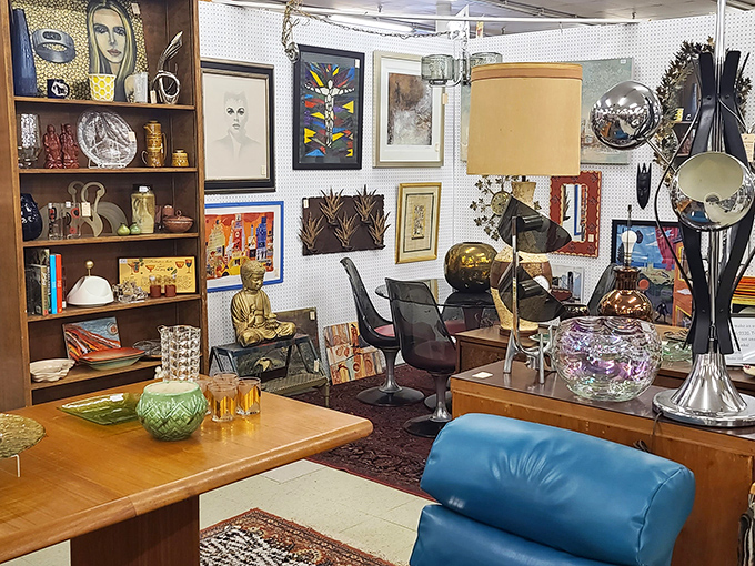 Mid-century modern meets eclectic art gallery in this stylish vendor space. That blue leather chair has definitely seen some interesting conversations.