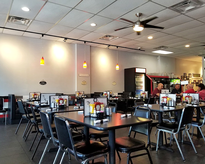 The calm before the breakfast storm. Simple tables, comfortable chairs, and pendant lighting create the stage where morning magic happens daily.