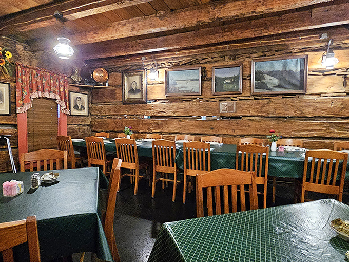 The original log cabin walls tell stories spanning centuries. If only these wooden beams could share what they've witnessed over countless meals.