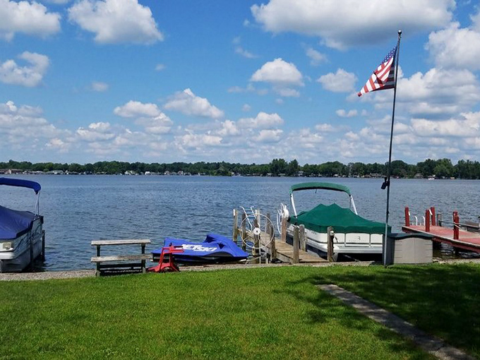 The quintessential summer dock scene: boats standing ready, flag waving, and that perfect patch of grass for your "I'm officially on vacation" nap.