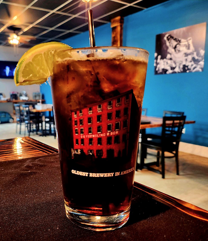 A proper cocktail with a lime wedge perched on the rim like it's enjoying the view. The perfect companion while deciding between ribeye and filet.