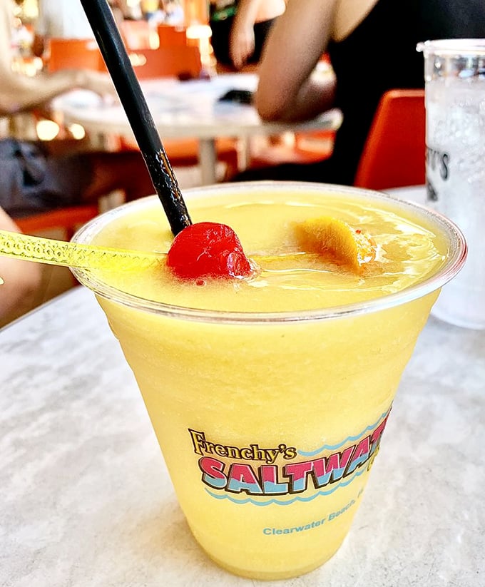 Liquid sunshine in a glass! This tropical concoction, adorned with cherry and pineapple, promises vacation vibes with every sip&mdash;no plane ticket required.