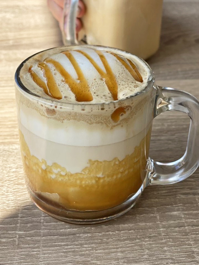 Coffee artistry that makes Monday mornings bearable&mdash;caramel drizzle creating a Jackson Pollock masterpiece in a mug.