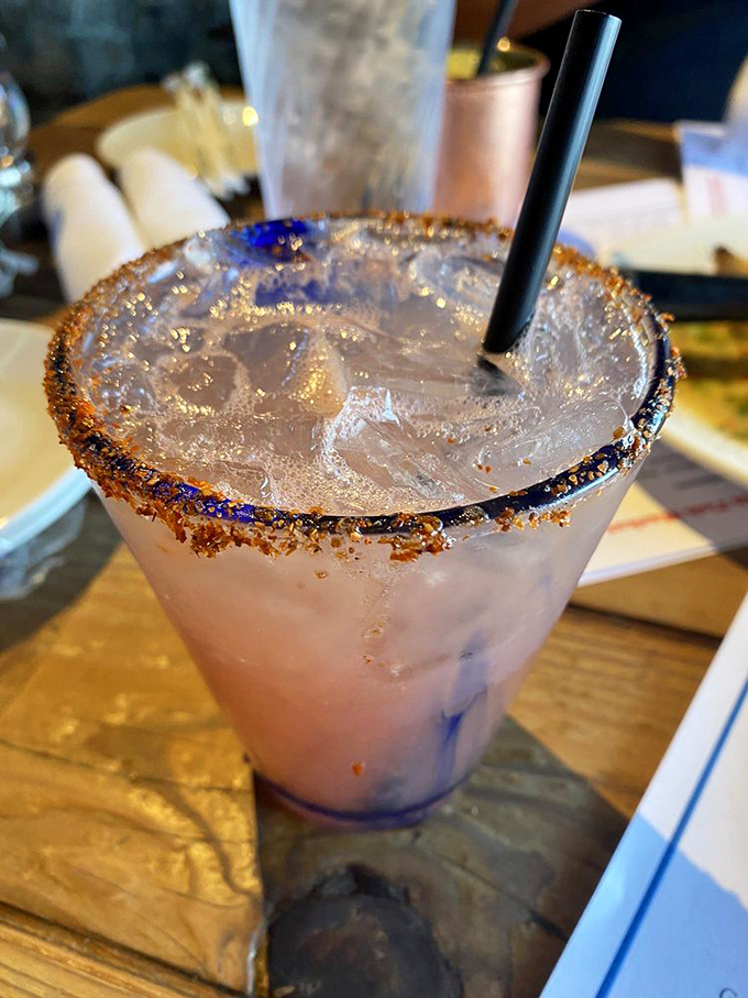 The cocktail's rim sparkles like the Pacific at sunset. Whatever's inside that glass, it's about to make your afternoon considerably better.