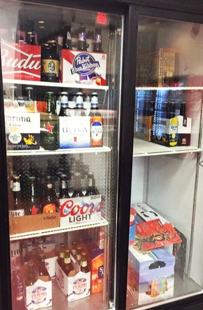 The "beer to go" sign is like a beacon of hope for those nights when you need both pizza and something to wash it down with.