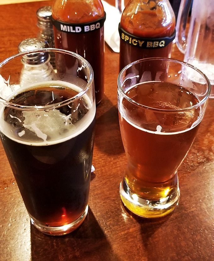 Two beers and house sauces standing by&mdash;because proper barbecue hydration is a science and an art form.