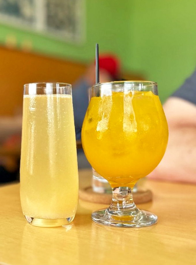 Morning libations that brighten the day – one mimosa-golden, one subtly effervescent, both promising good things ahead.