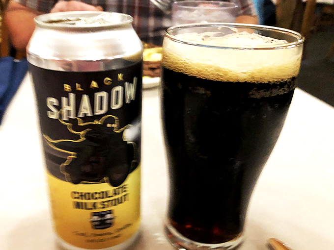 Even the beverages here feel like an event. That stout looks dark enough to have its own gravitational pull.