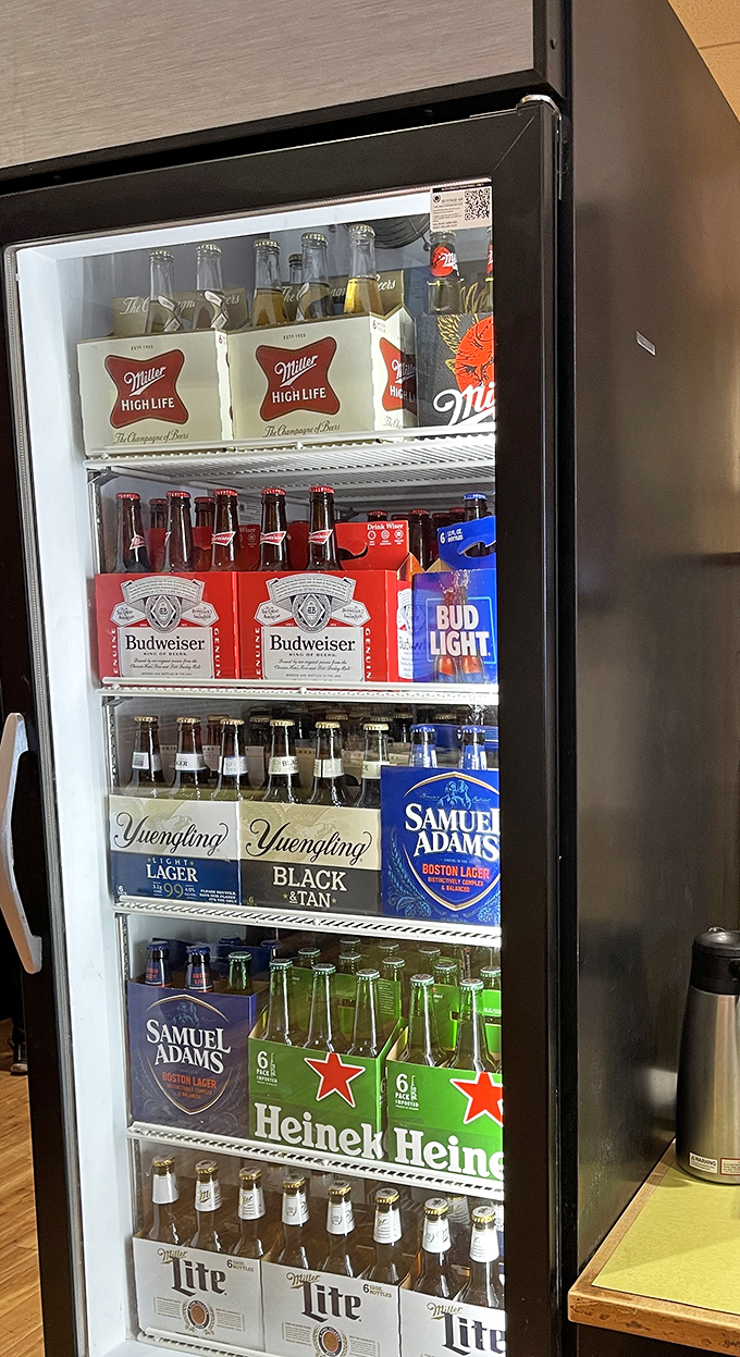 The beer fridge stands ready like an old friend, offering everything from workday Miller Lite to weekend-worthy craft options. Decisions, decisions.
