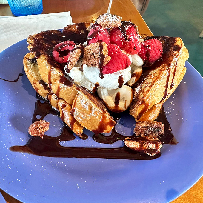 Waffles that have clearly been to finishing school. Those raspberries and chocolate sauce aren't just toppings&mdash;they're a morning celebration on a plate.