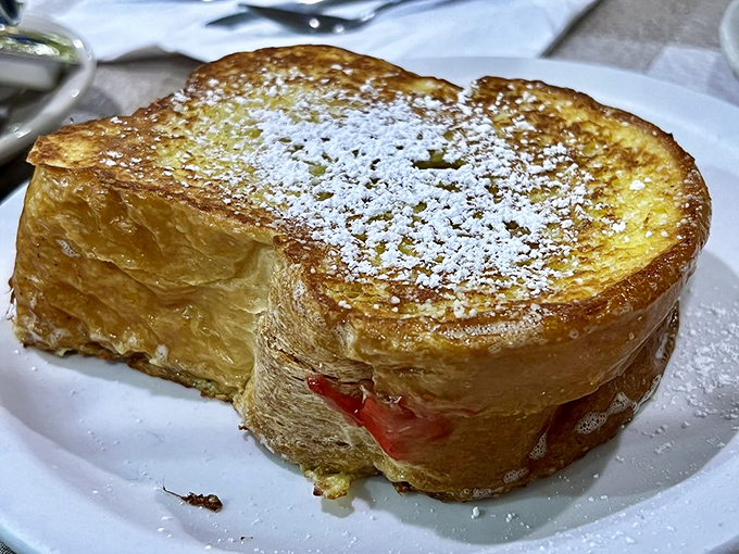 French toast that's dressed up for the occasion&mdash;powdered sugar snowfall on a crispy golden landscape. The jam peek-a-boo is just showing off.