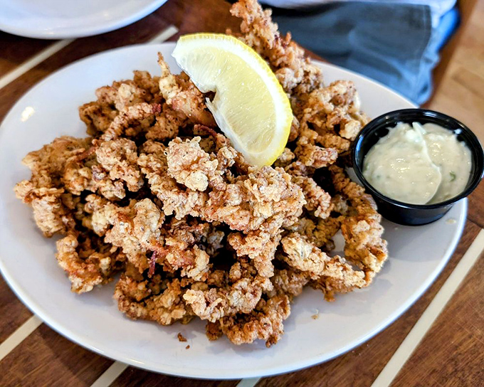 Fried clam strips that crackle with each bite, served with a tangy sauce that makes you wonder why you don't eat these every day.