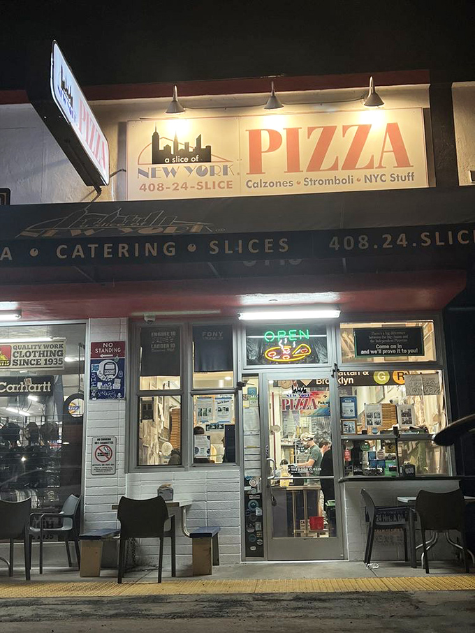 The evening glow reveals a neighborhood gem that's been quietly perfecting pizza while others chase trends.