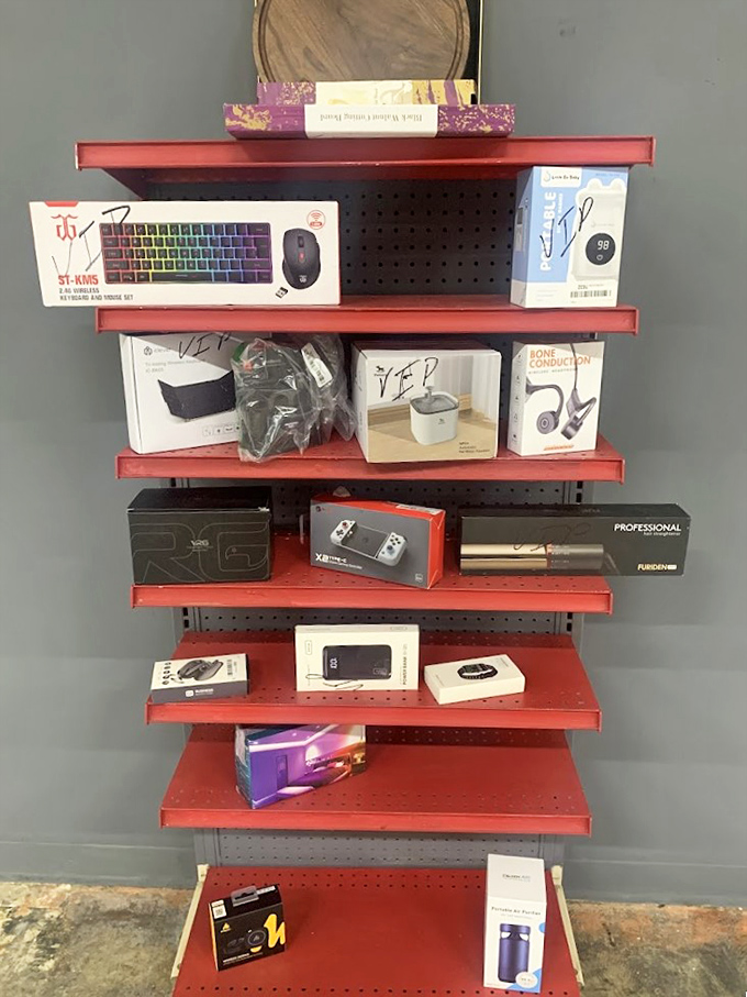 Tech treasures line these red shelves like an electronics buffet. That gaming controller could be your living room's missing piece!