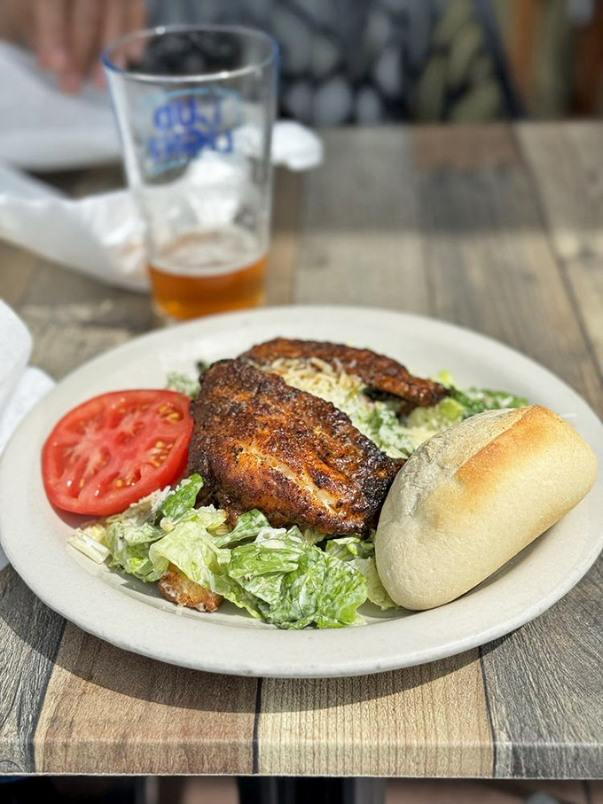 Blackened grouper resting on a Caesar salad isn't just lunch&mdash;it's a flavor intervention. That perfectly charred crust is where the magic happens.