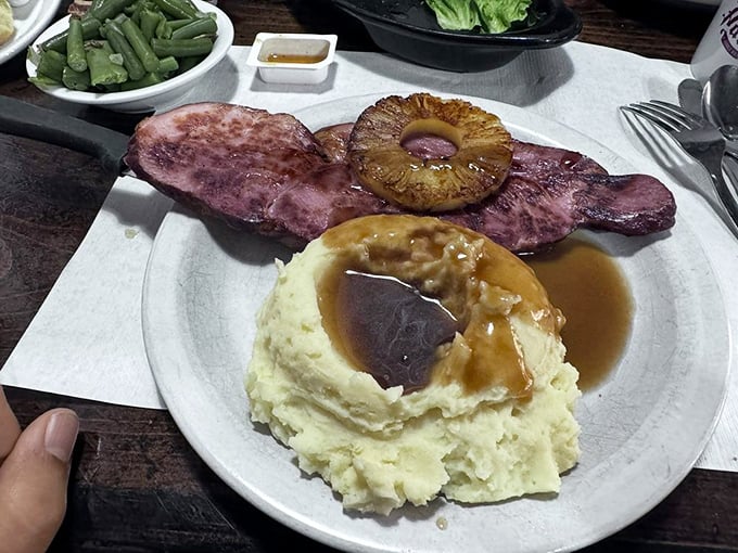 Ham steak that's dressed for success with a pineapple ring "hat," alongside mashed potatoes with a gravy "pool" that you'll want to dive into.