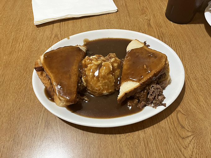 Hot beef sandwich: where bread becomes a throne for tender meat, and gravy flows like the tears of joy you'll shed while eating it.