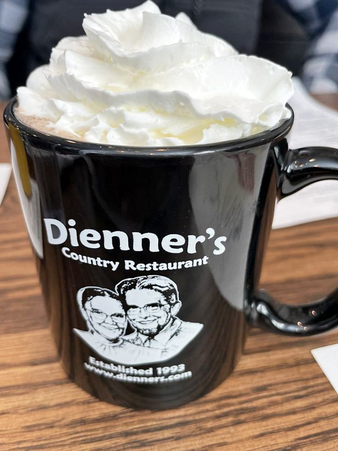 Hot cocoa crowned with whipped cream in their signature mug makes every sip feel like home.