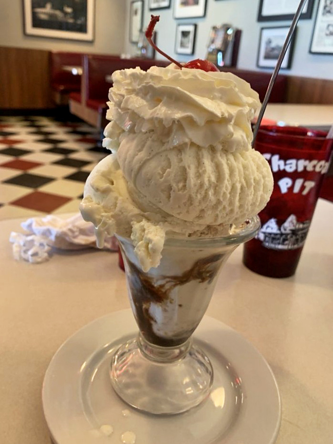 Ice cream architecture at its finest. This towering sundae, crowned with whipped cream and a cherry, is what childhood dreams and adult indulgences are made of.