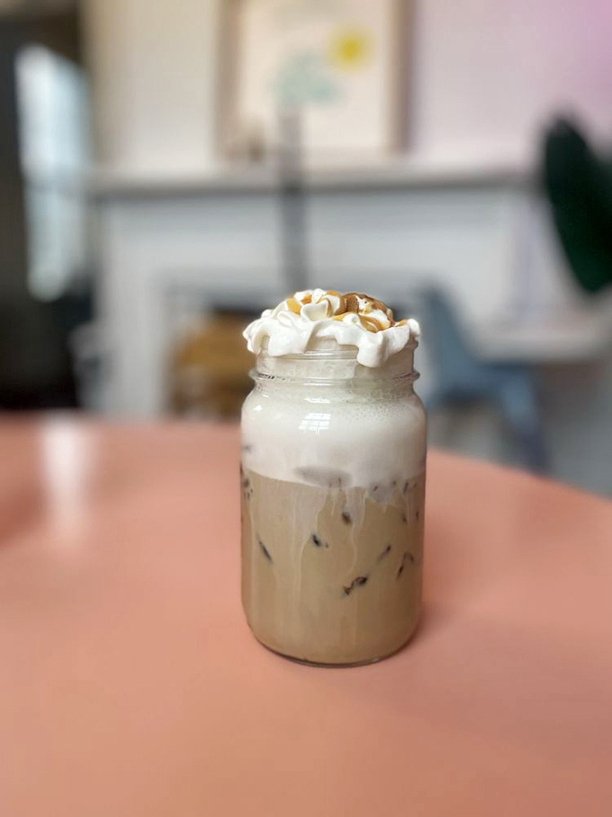 This isn't just iced coffee—it's summer in a mason jar, topped with a cloud of whipped cream that's begging for its own Instagram account.
