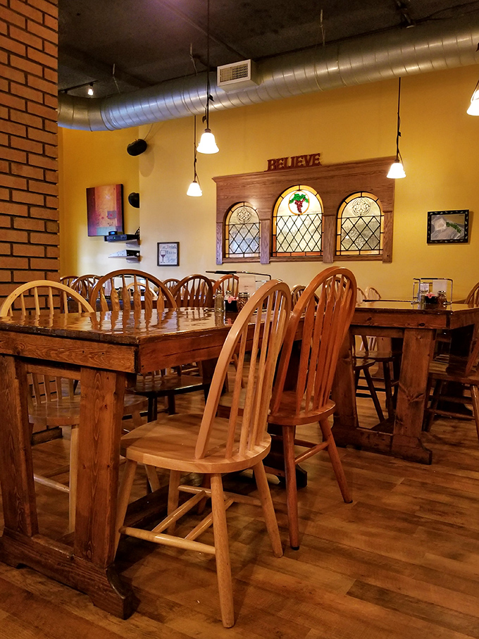 Stained glass windows and "BELIEVE" signage watch over rustic wooden tables where countless memorable meals have unfolded.