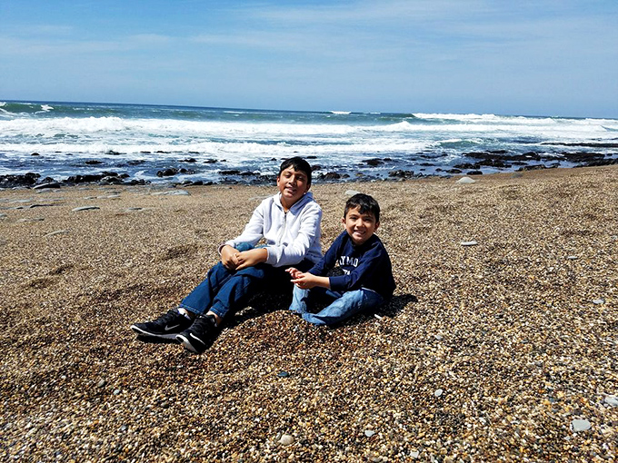 Childhood joys at their simplest: two kids, a beach of perfect pebbles, and the kind of unscheduled afternoon that becomes the standard by which all vacations are measured.