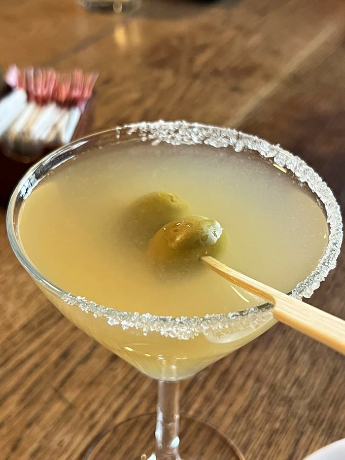 A crystal-clear martini with a salt rim and olive garnish&mdash;the civilized way to begin your Texas steakhouse adventure.