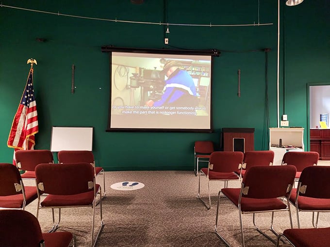 Learning in comfort! The museum's presentation room, with its deep green walls and cherry-red chairs, prepares visitors for their journey into transit history.