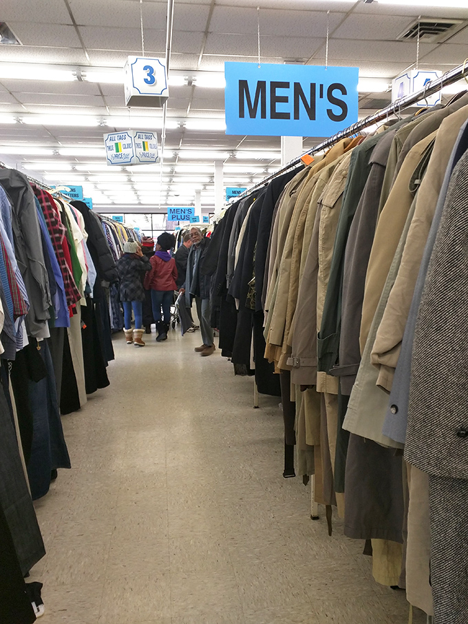 Men's coats stand at attention like a well-dressed army. That perfect blazer or winter coat is hiding somewhere in this sartorial lineup.