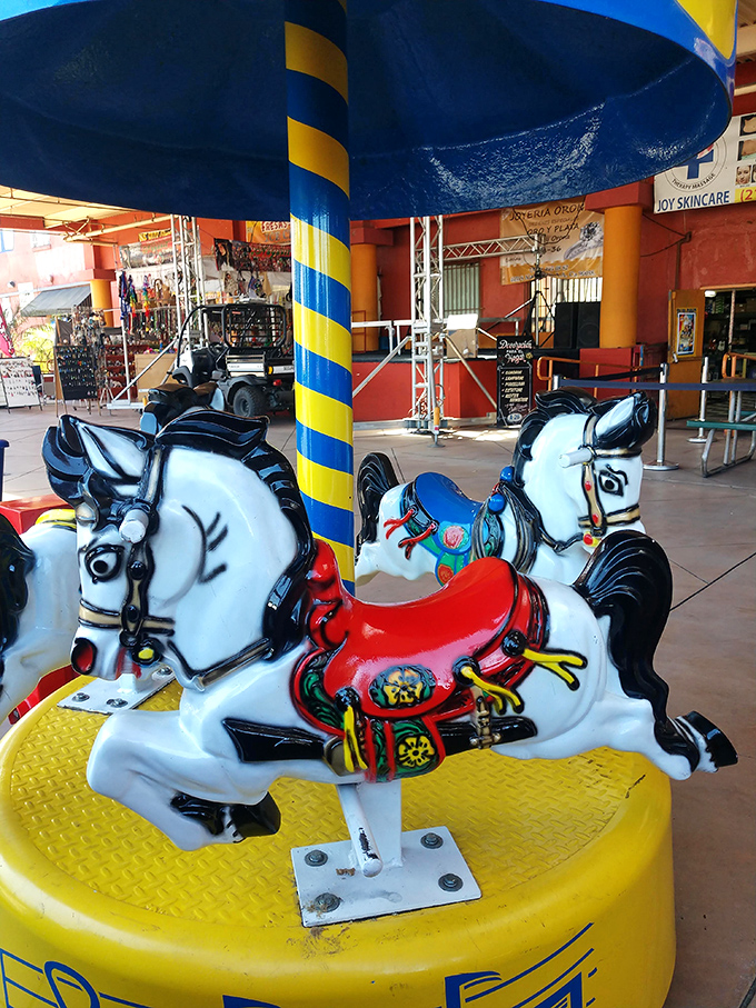 Childhood joy for pocket change! These carousel horses have carried generations of children while parents browse nearby, a timeless swap meet tradition.
