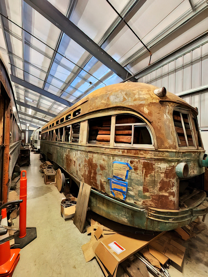 A trolley restoration project in progress &ndash; this sleeping beauty awaits its transformation from rusted relic to gleaming museum star. Every peeling paint patch tells a story.