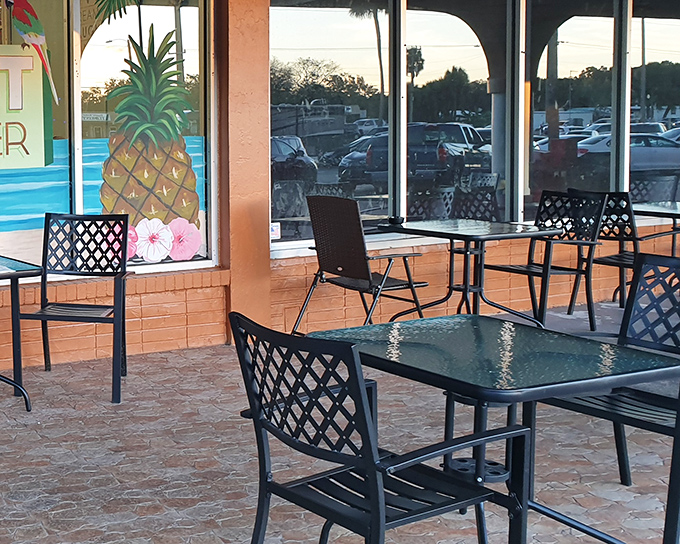 The outdoor seating area, where the pineapple mural reminds you you're in Florida, even if your northern relatives won't stop texting about snow.