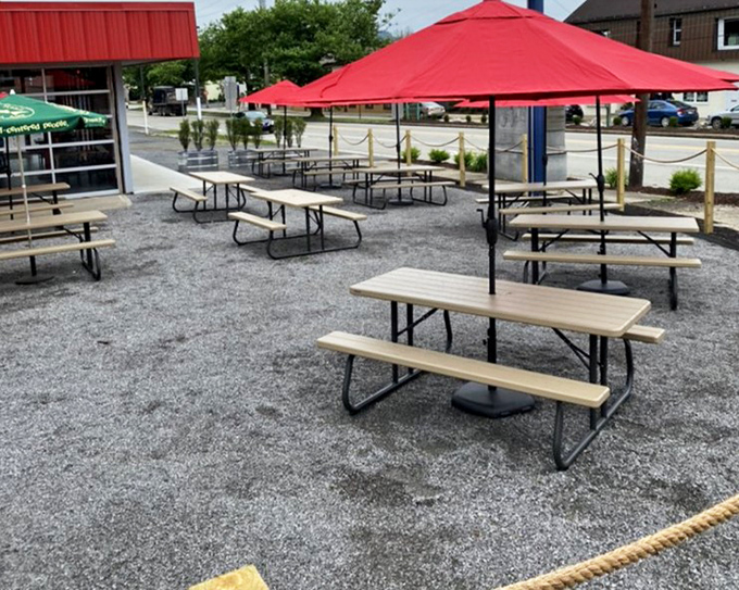 The outdoor seating area, where picnic tables under red umbrellas invite you to enjoy your barbecue feast with a side of fresh Pennsylvania air.