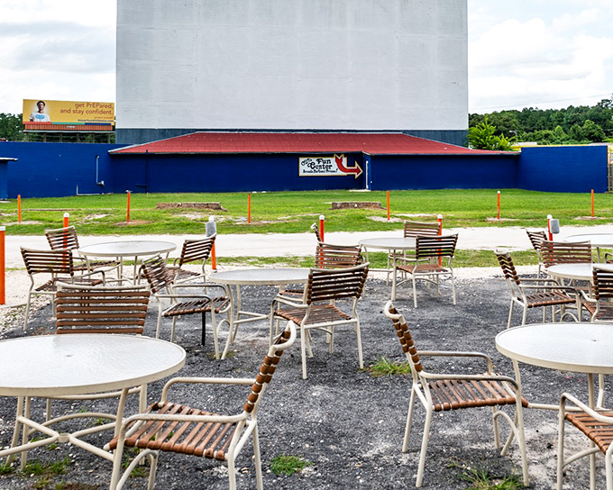 These outdoor tables facing the massive screen offer the best of both worlds&mdash;the comfort of restaurant seating with the magic of outdoor cinema.