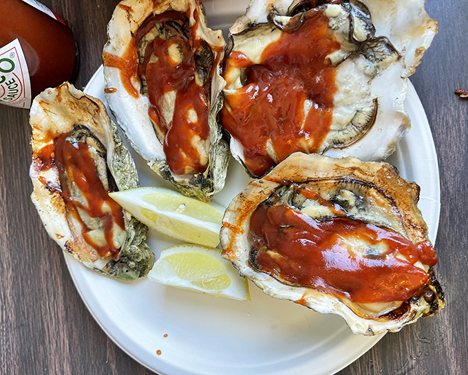 Plump oysters glistening with sauce and paired with lemon wedges. The ocean's perfect delivery system for briny, buttery bliss.