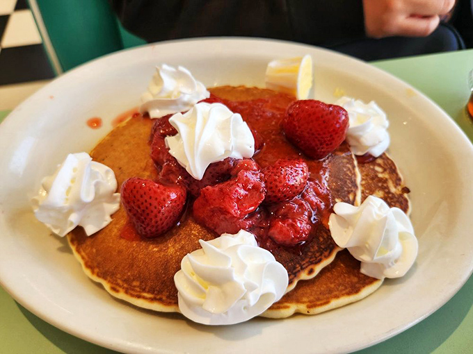 Pancakes wearing a crown of fresh strawberries and whipped cream. Breakfast royalty that makes waking up early completely worth it.