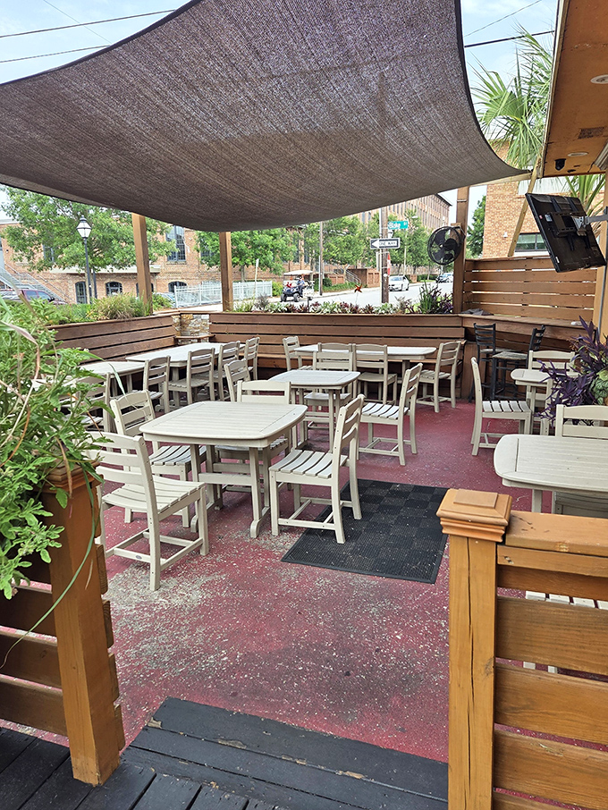 The outdoor patio offers a breezy respite from Charleston's heat, where palm trees and shade sails create an urban oasis.
