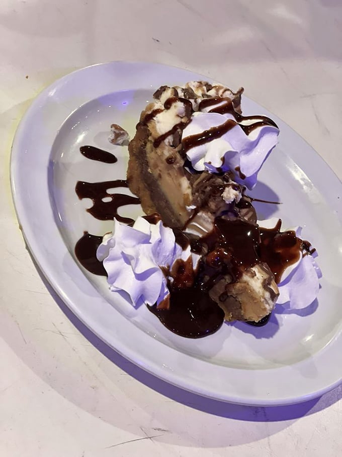 This isn't just dessert &ndash; it's therapy on a plate. Peanut butter pie with chocolate drizzle and whipped cream mountains.