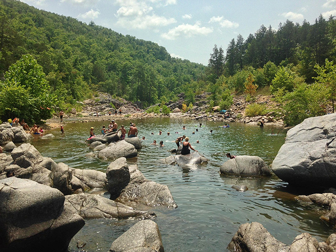 Summer's perfect playground where visitors become human otters, lounging on sun-warmed rocks between refreshing dips in crystal pools.