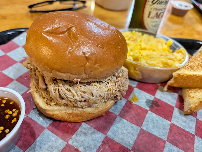 A pulled pork sandwich that requires both hands and several napkins. The bread exists merely as a delivery system for smoky, tender perfection.