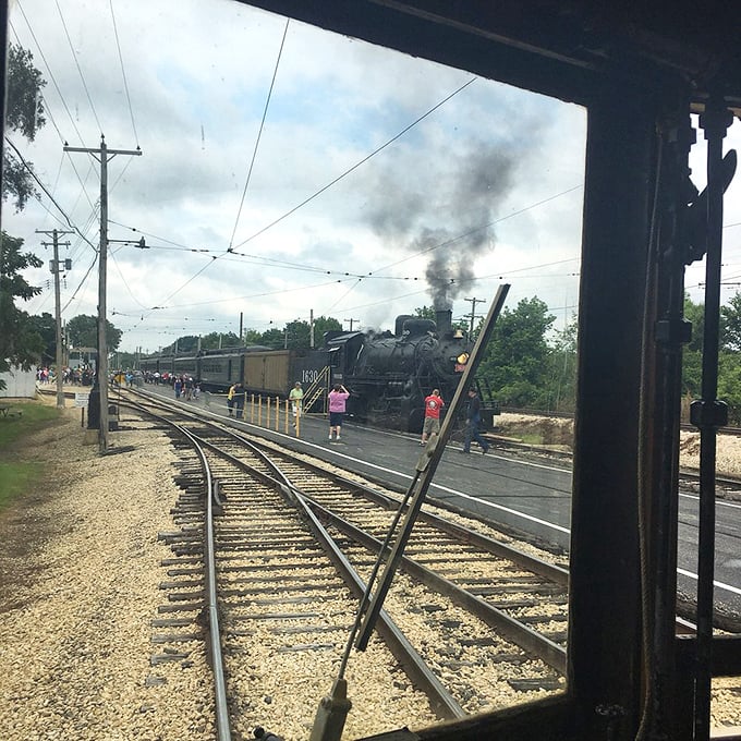 Steam billows dramatically from a massive locomotive as it pulls into the station&mdash;a sensory spectacle of sight, sound, and smoky nostalgia.