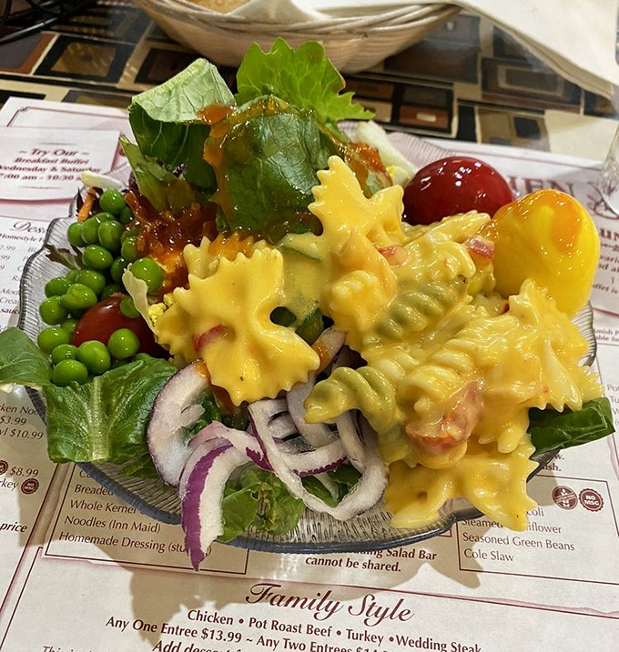 This pasta salad isn't just a side dish &ndash; it's a vibrant celebration on a bed of greens, where every bite invites you to the party.