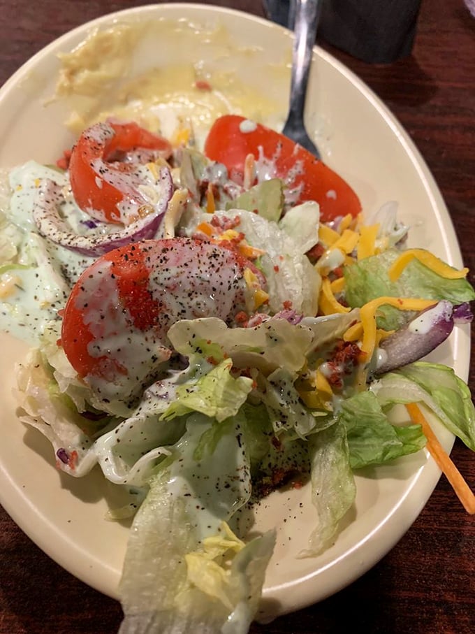 A salad appears, bringing token greenery to the table. It's the diplomatic envoy from the vegetable kingdom to meat country.