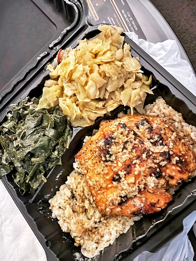 Soul food elegance: perfectly cooked salmon resting on rice with collard greens and cabbage that would make any Southern grandmother proud.